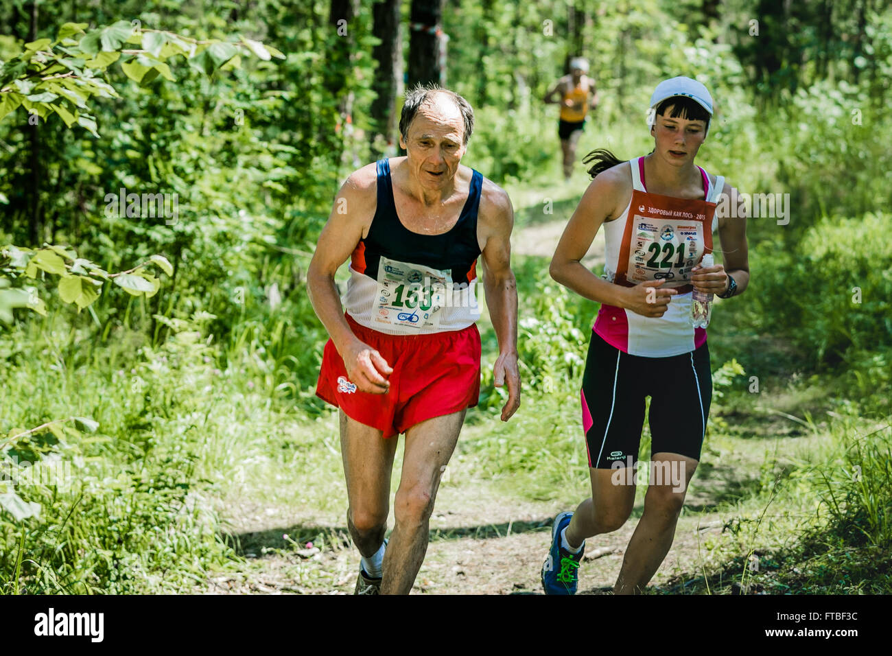 Miass, Russia - June 28, 2015: old man and the girl run during marathon ...