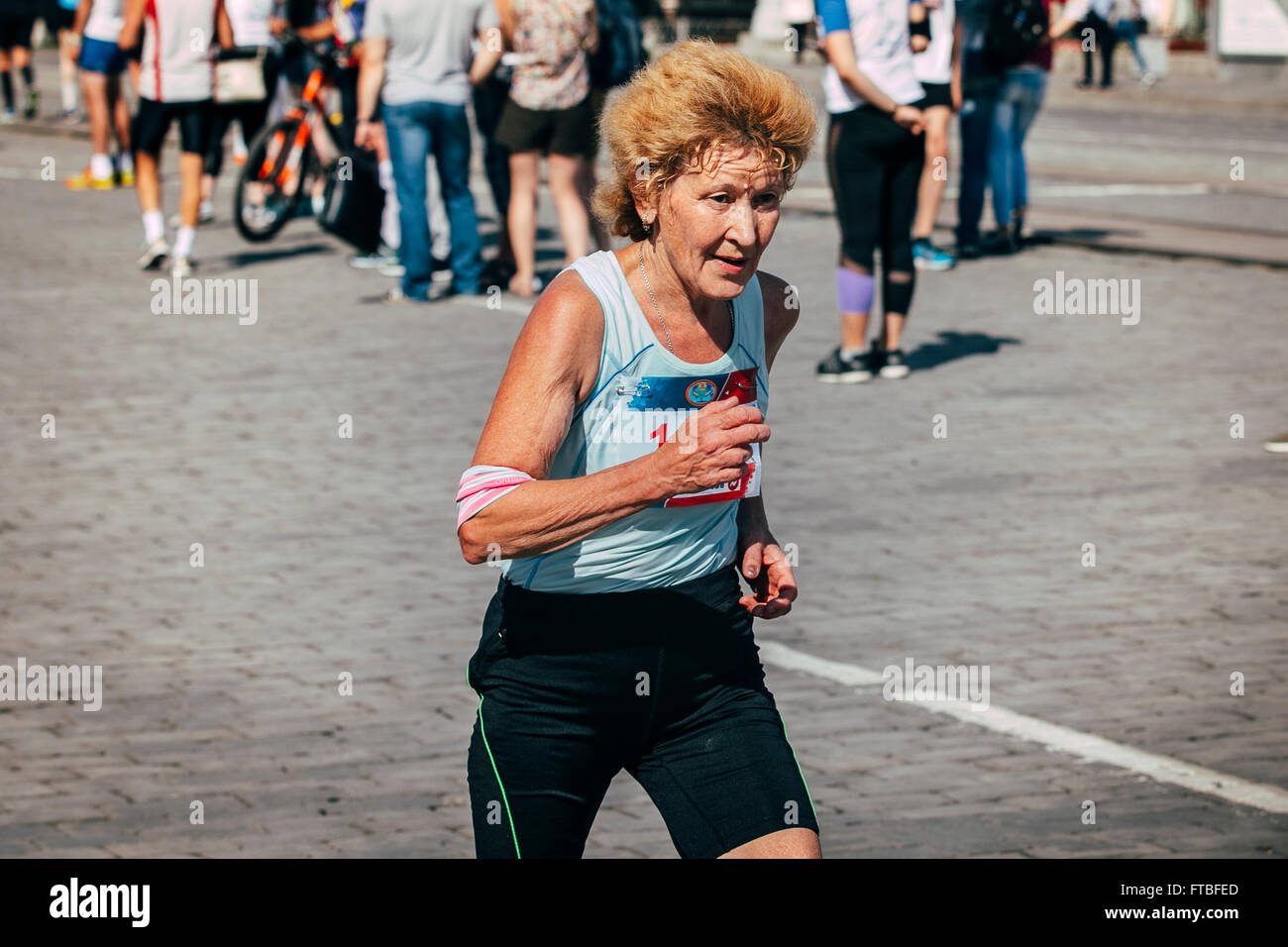 Ekaterinburg, Russia - August 01, 2015: old woman runner competes ...