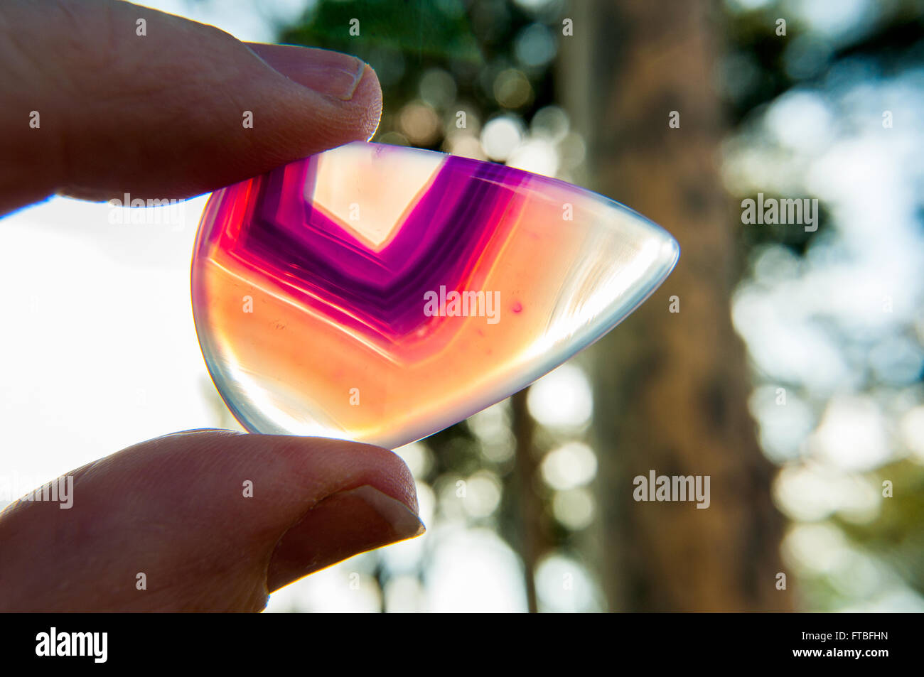 Natural banded agate mineral stone on location in park Stock Photo - Alamy