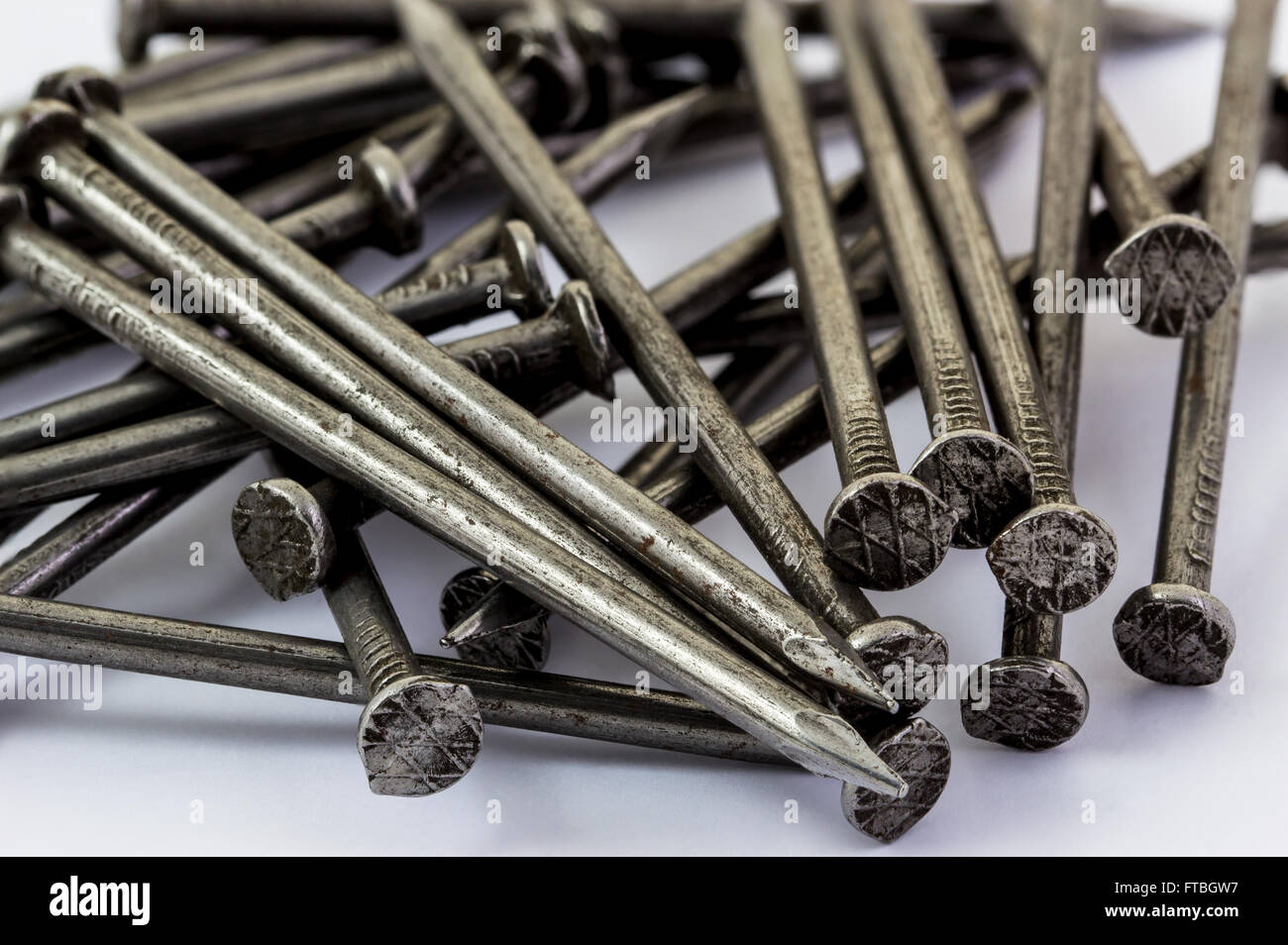 Metal nails on white background Stock Photo - Alamy