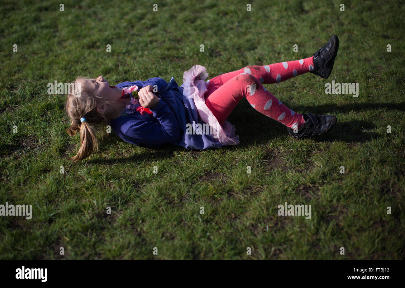 Girl rolling down hill hi-res stock photography and images - Alamy