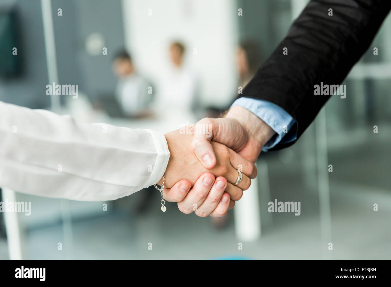 Business people shaking hands in the office Stock Photo - Alamy