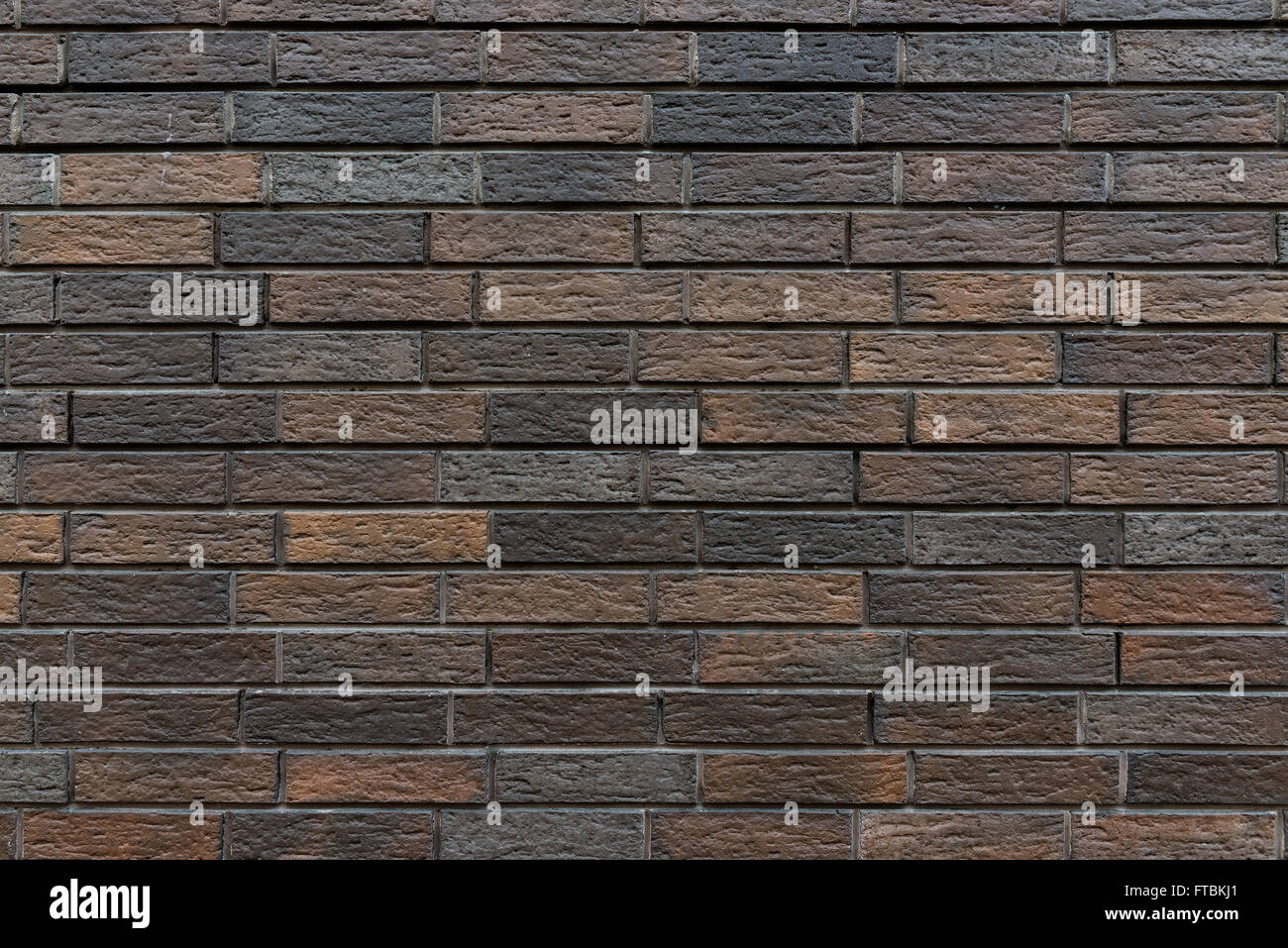 Texture of a wall made of low profile dark and grey bricks. Moscow ...
