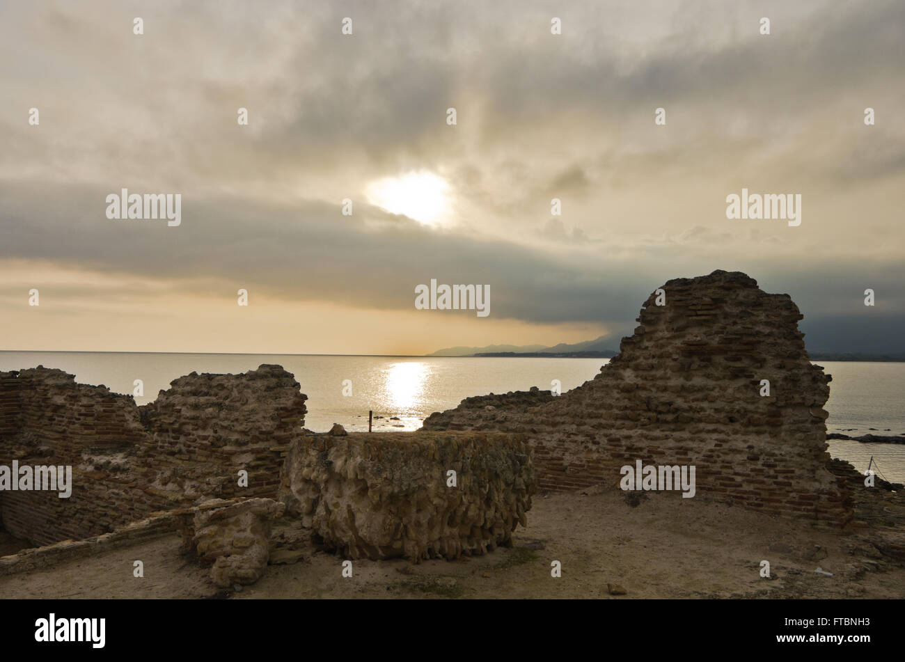 Sunset on a beach at Nora archeological site, near city of Pula, island ...