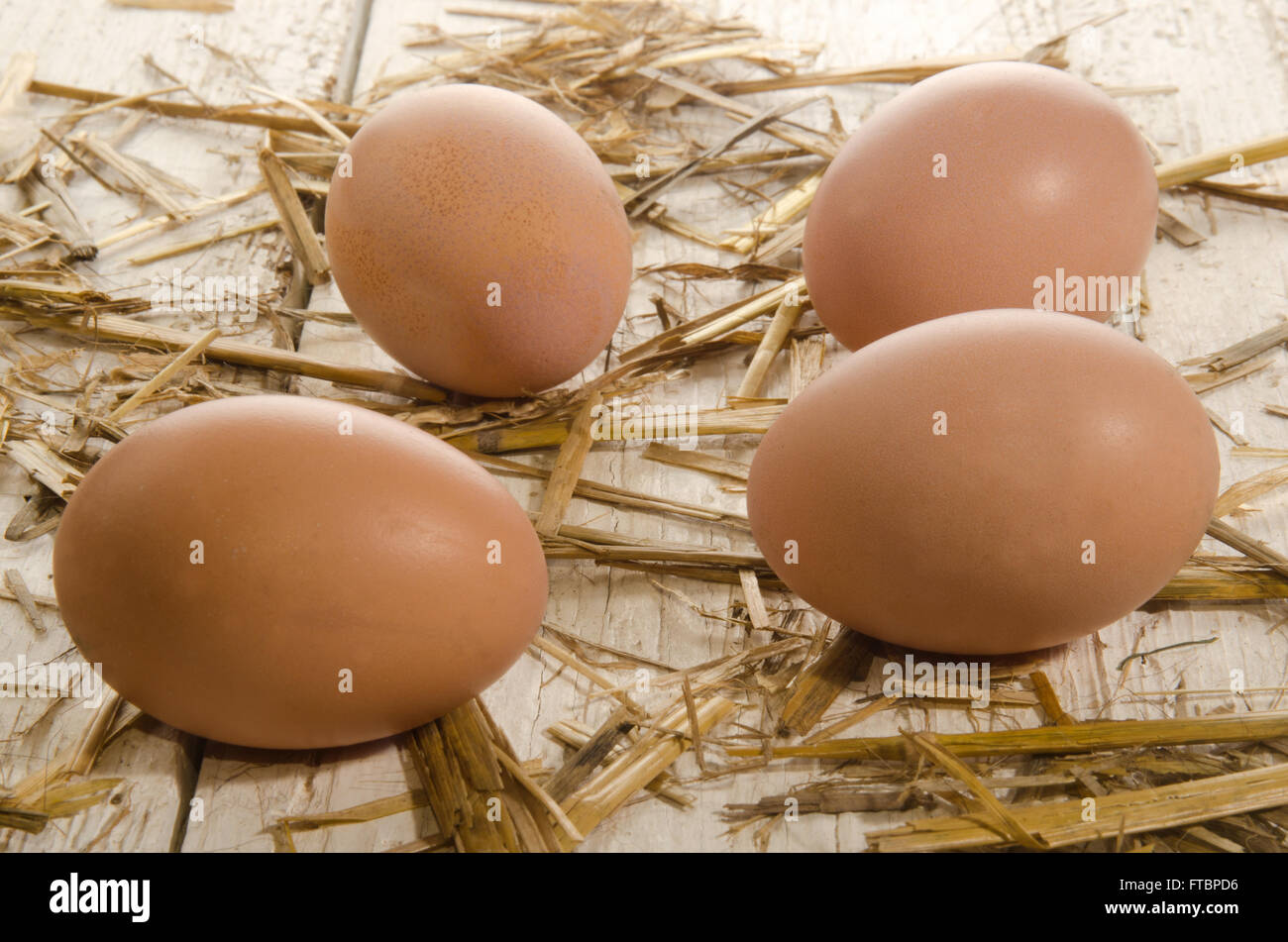 free range brown eggs with straw on an old white wooden table Stock ...