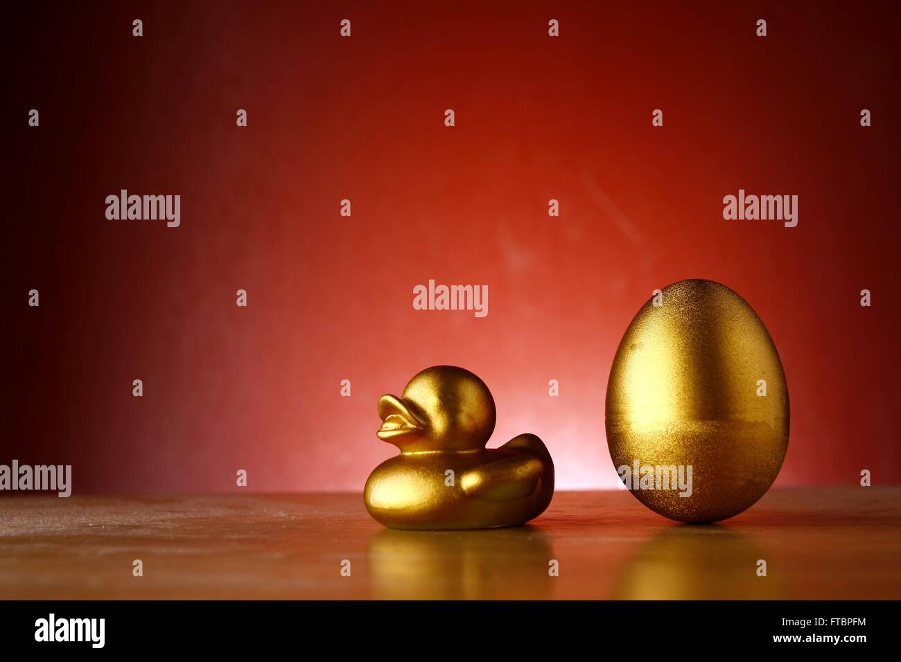 Golden egg and golden duckling Stock Photo - Alamy