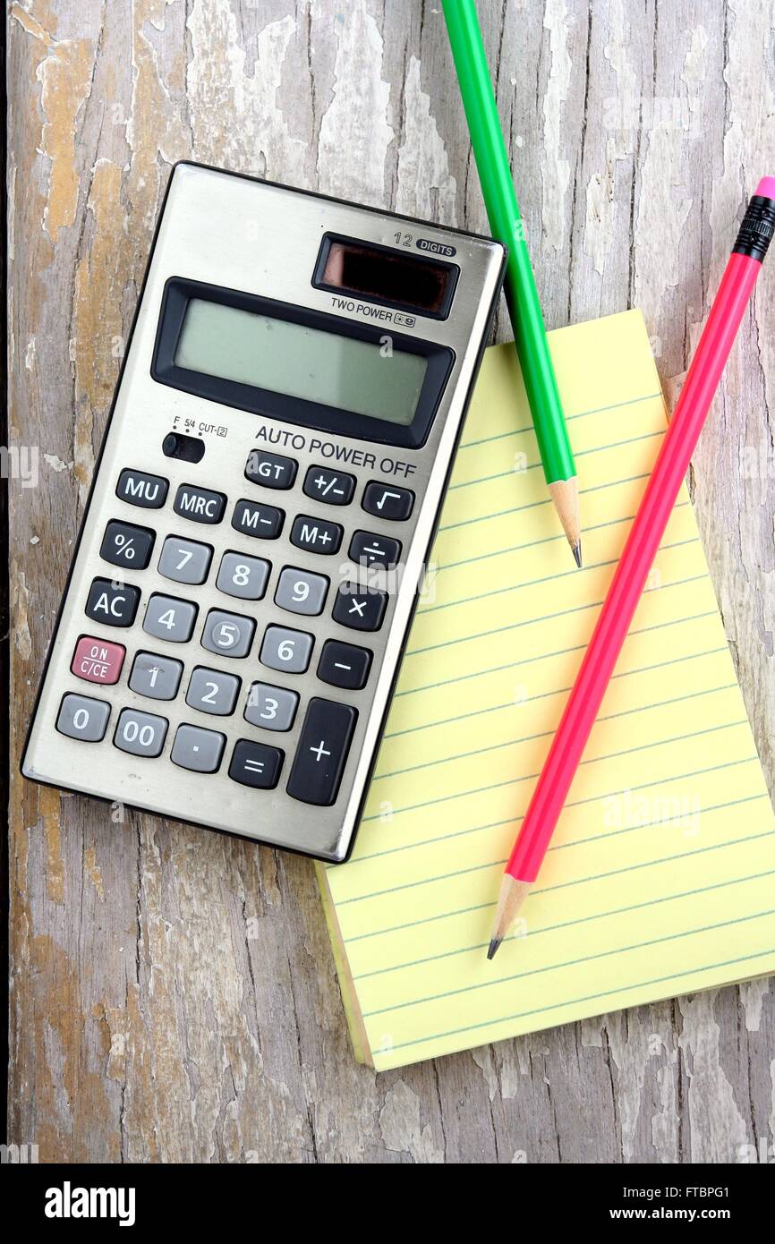 calculator, colored pencils and notepad Stock Photo - Alamy