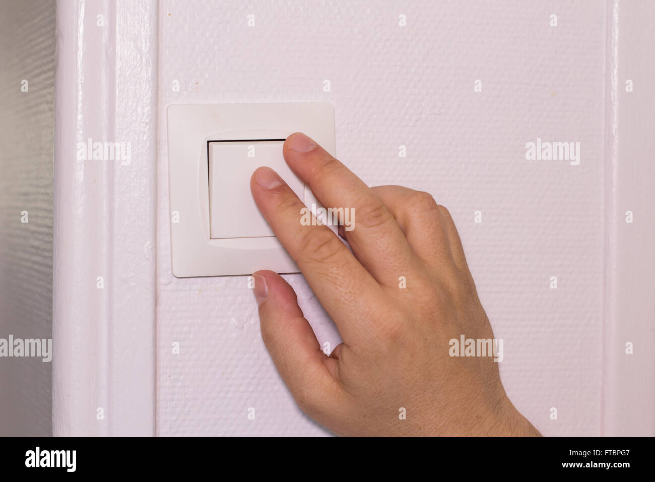 Fingers push electrical switch Stock Photo - Alamy