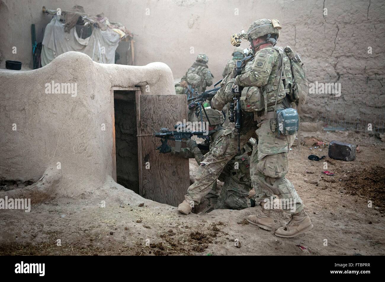 U.S. Army paratroopers with the 82nd Airborne Division search a cellar ...