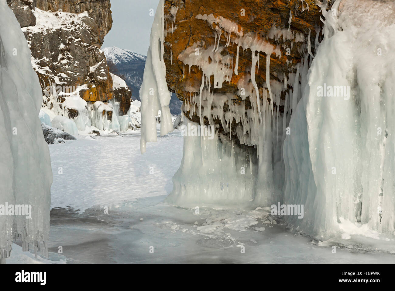 Huge icicles on rocks Stock Photo - Alamy