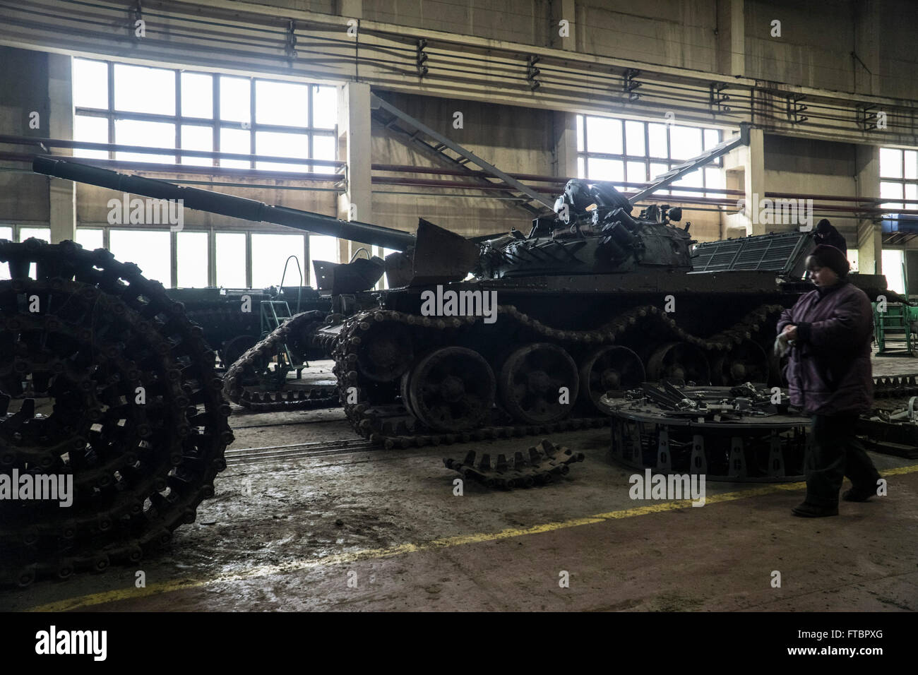 A cleaner is seen in the tank repair workshop at the Lviv Armour Plant ...