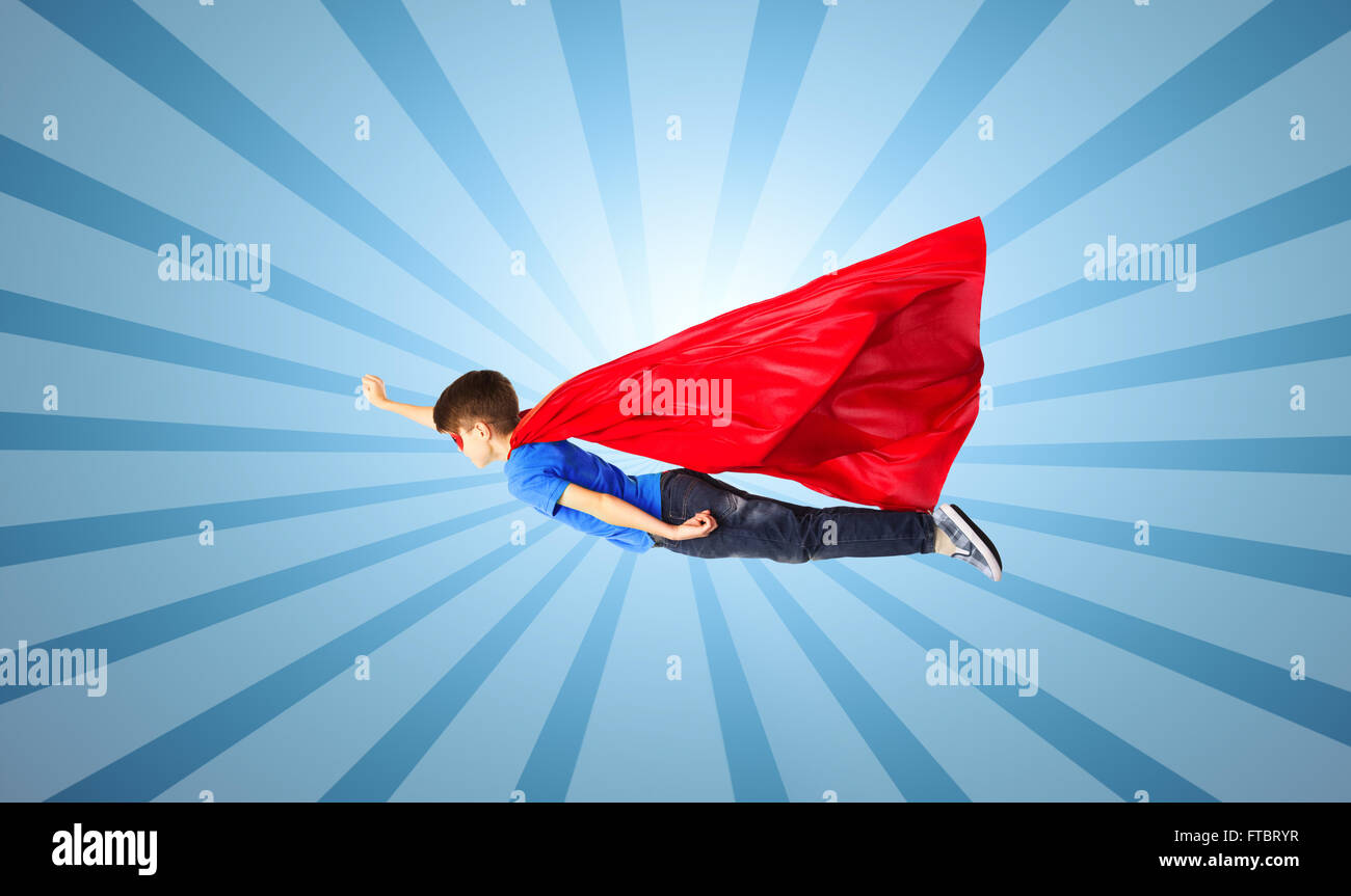 boy in red superhero cape and mask flying on air Stock Photo - Alamy