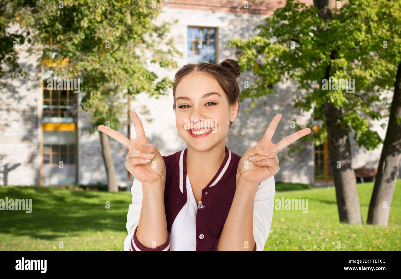 happy teenage student girl showing peace sign Stock Photo - Alamy