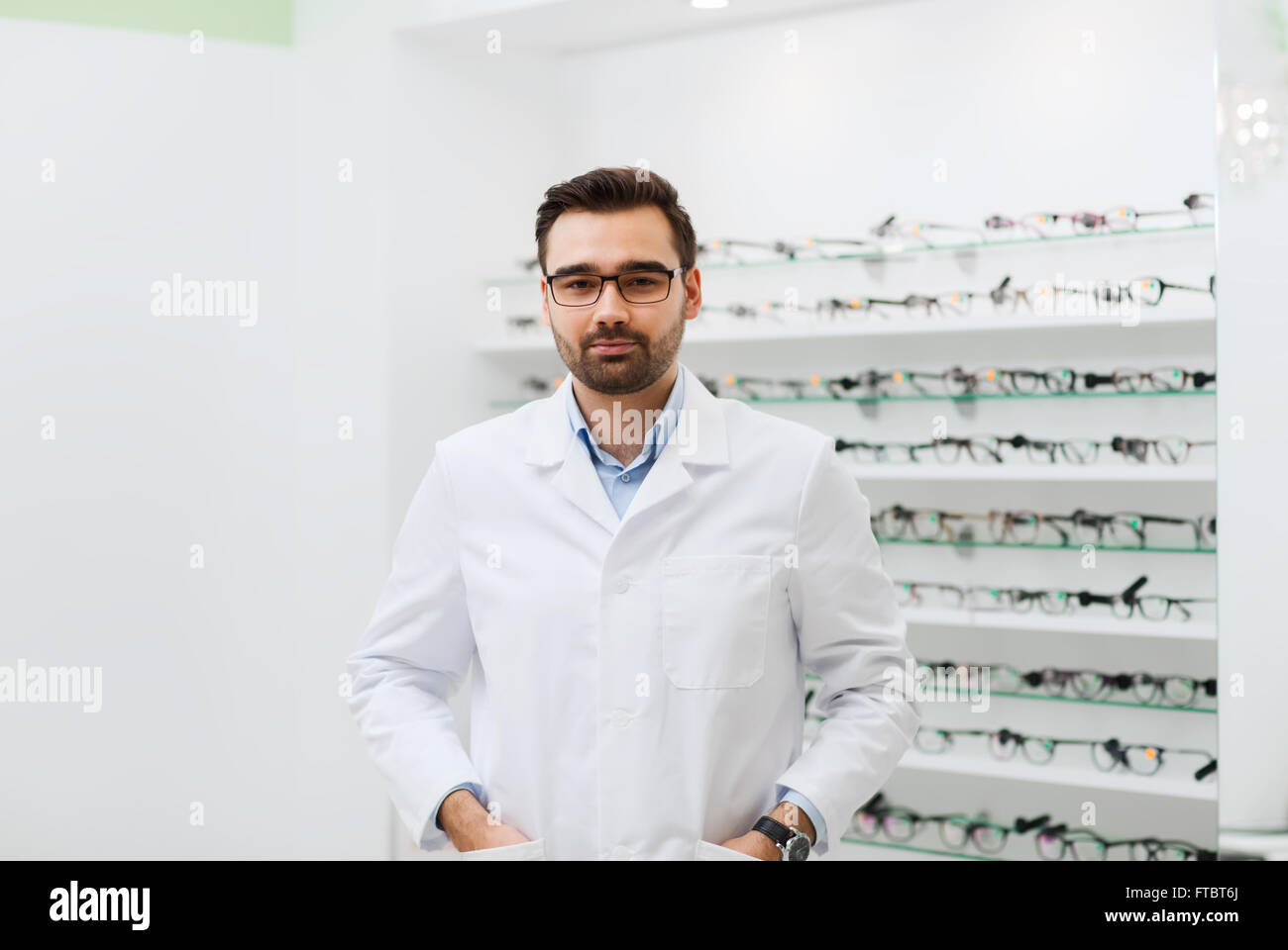 man optician in glasses and coat at optics store Stock Photo - Alamy