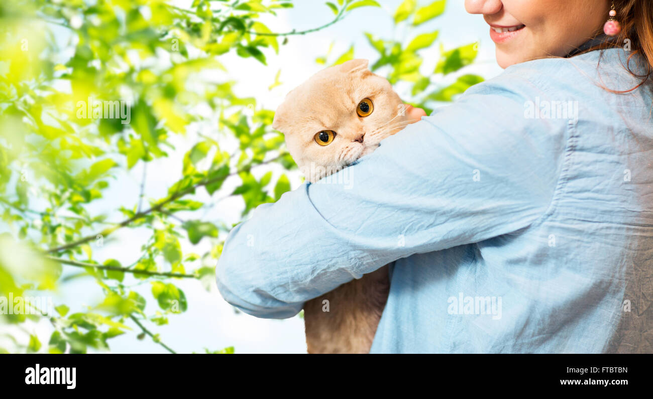 woman holding scottish fold cat over tree Stock Photo - Alamy
