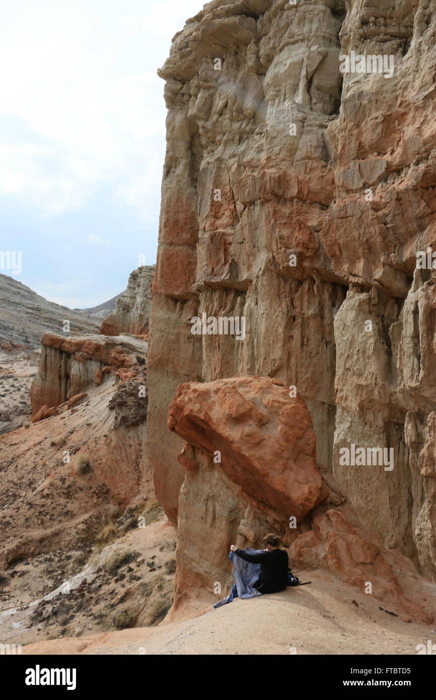hiker Cliffs and sandstone, tilted rock layers Red Rock Canyon State ...