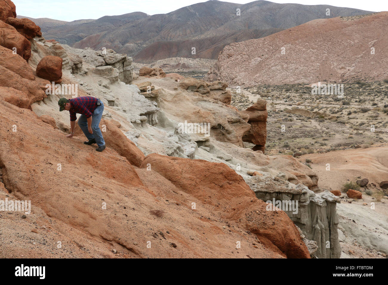 hiker Cliffs and sandstone, tilted rock layers Red Rock Canyon State ...
