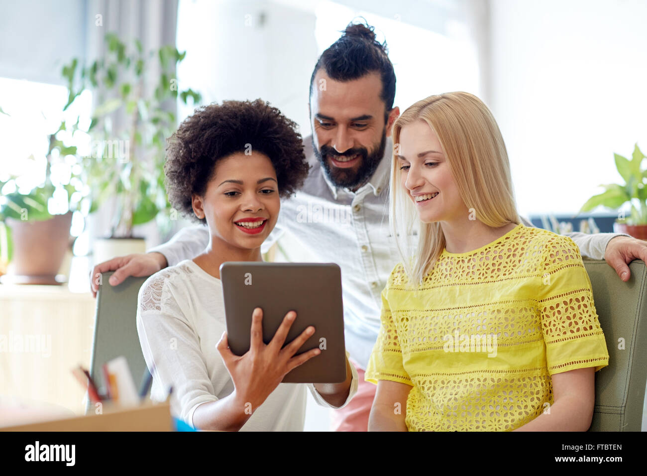 happy creative team with tablet pc in office Stock Photo - Alamy