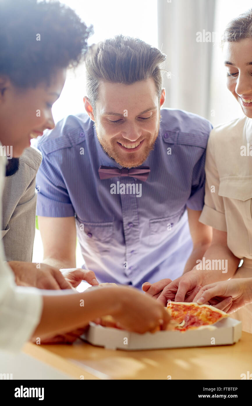 happy business team eating pizza in office Stock Photo - Alamy