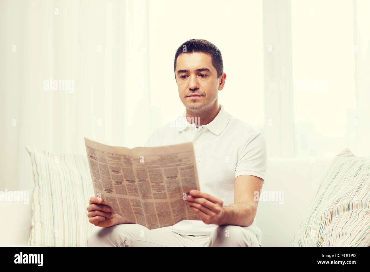 man reading newspaper at home Stock Photo - Alamy