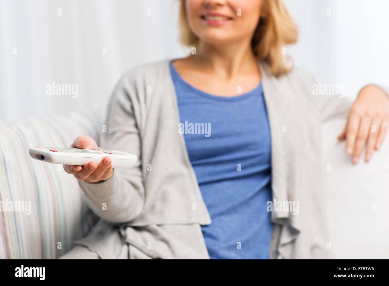 Woman tv remote hi-res stock photography and images - Alamy