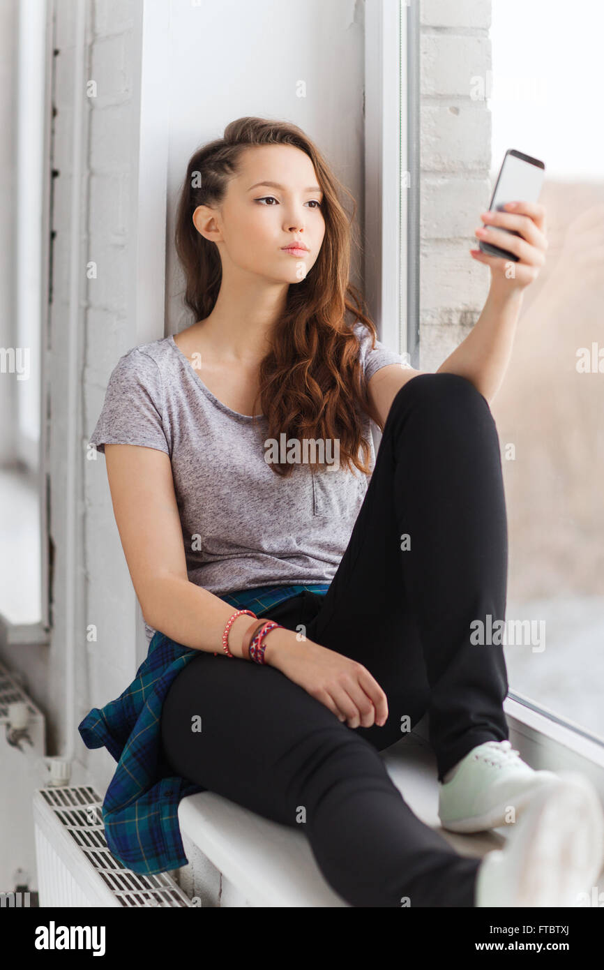 sad pretty teenage girl with smartphone texting Stock Photo - Alamy