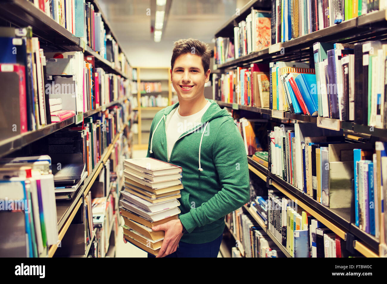 Man holding pile books hi-res stock photography and images - Alamy