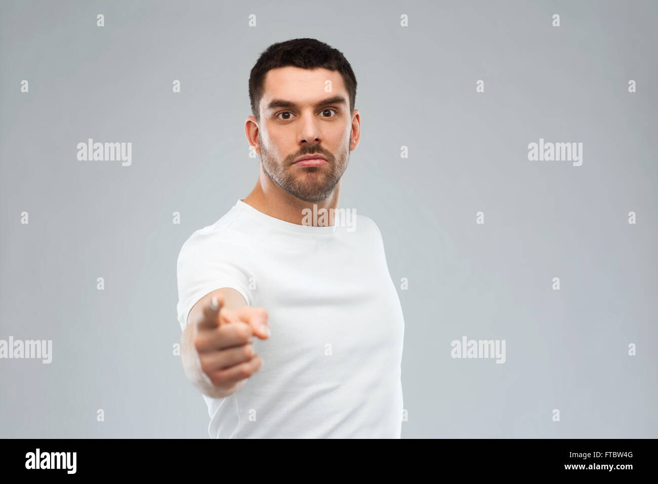 angry man pointing finger to you over gray Stock Photo - Alamy