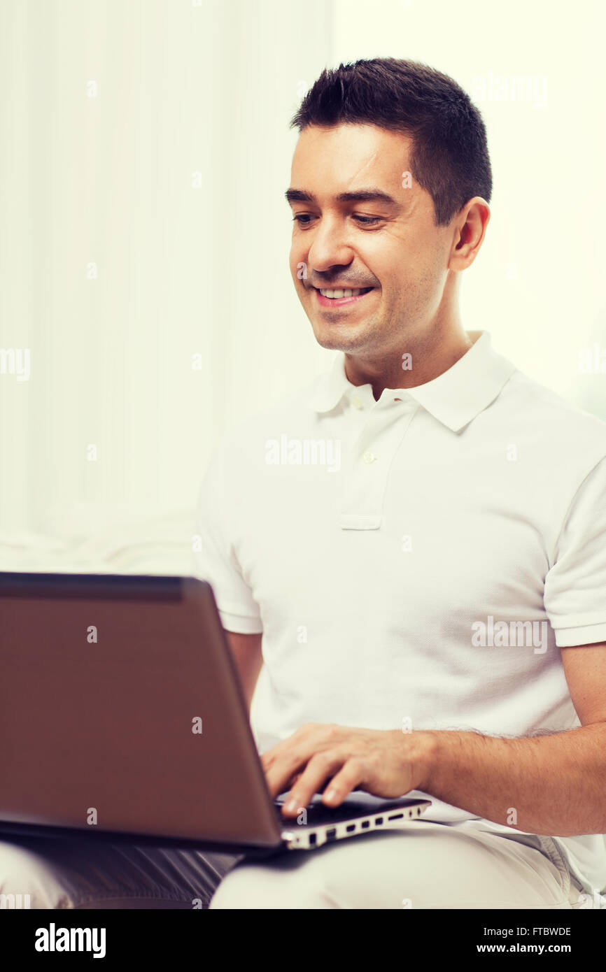 happy man working with laptop computer at home Stock Photo - Alamy