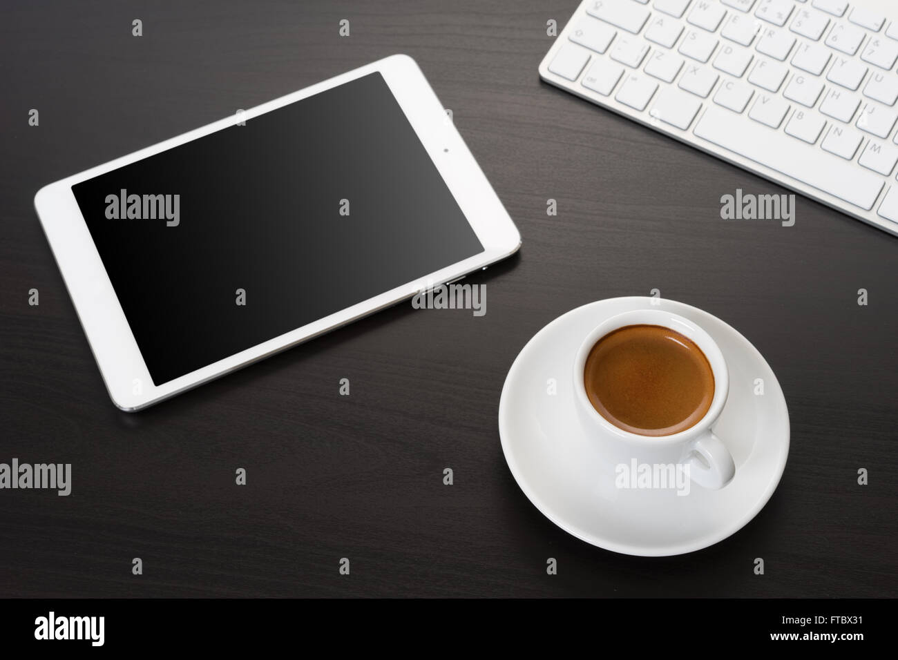 Touch tablet and coffee on office table Stock Photo - Alamy