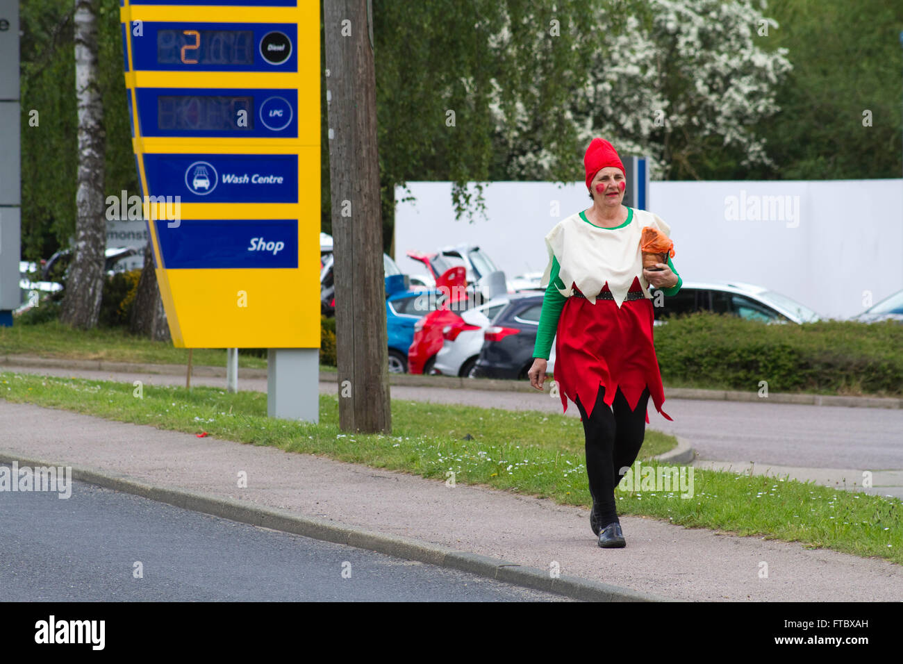 Older woman wearing Snow White dwarf costume walks to the start of a ...