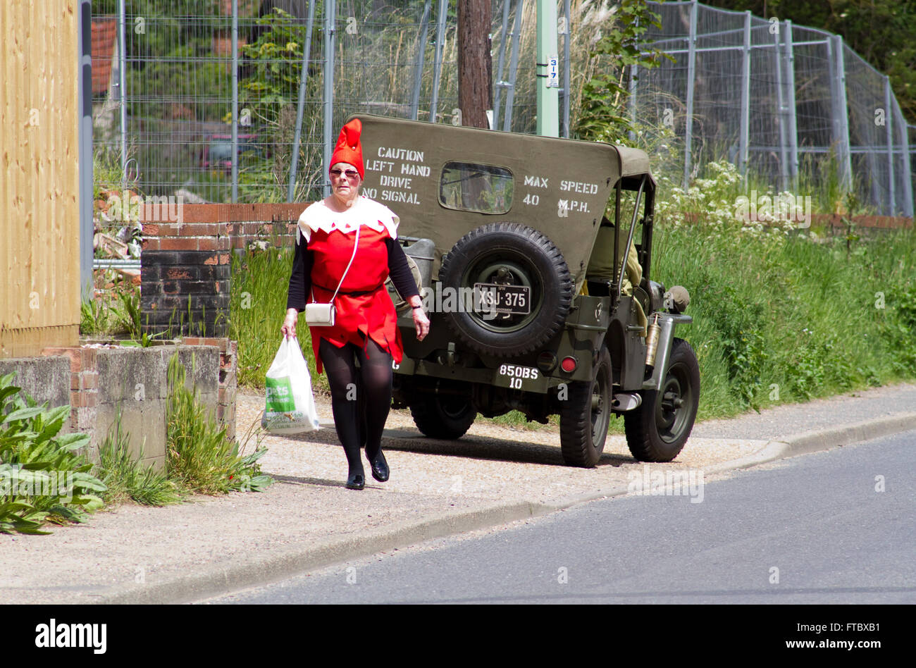 Older woman wearing Snow White dwarf costume walks to the start of a ...