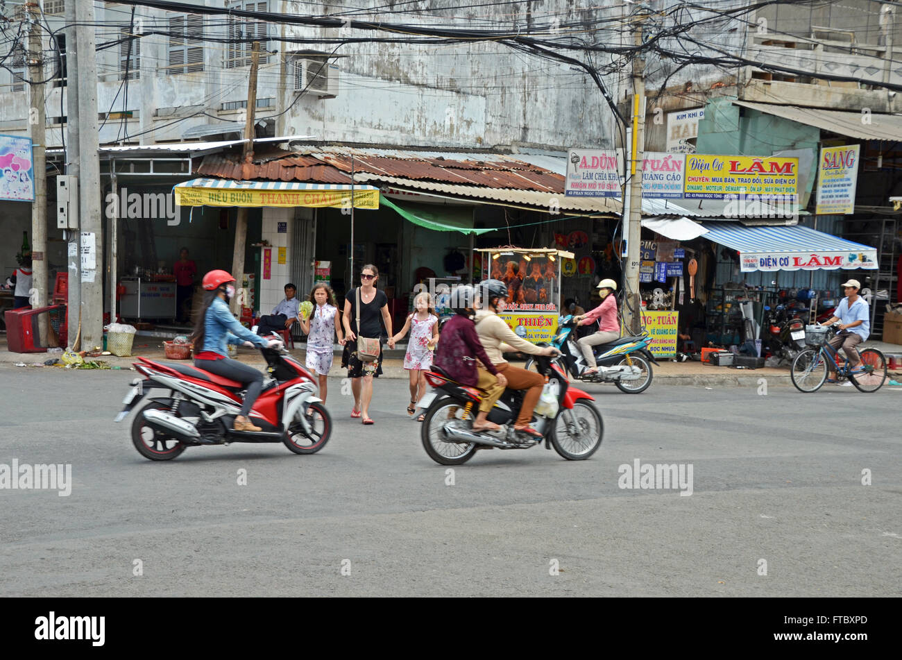 Tourists crossing a road in Ben Tre in the Mekong Delta region, Vietnam ...