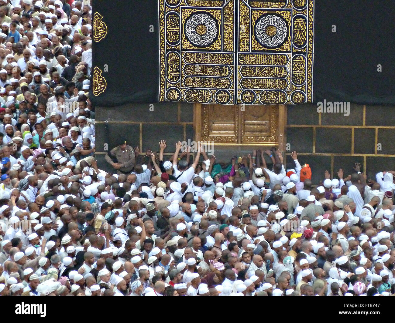 Thousands of Muslim hajj pilgrims touch the Holy Kaaba in the Al-Masjid ...