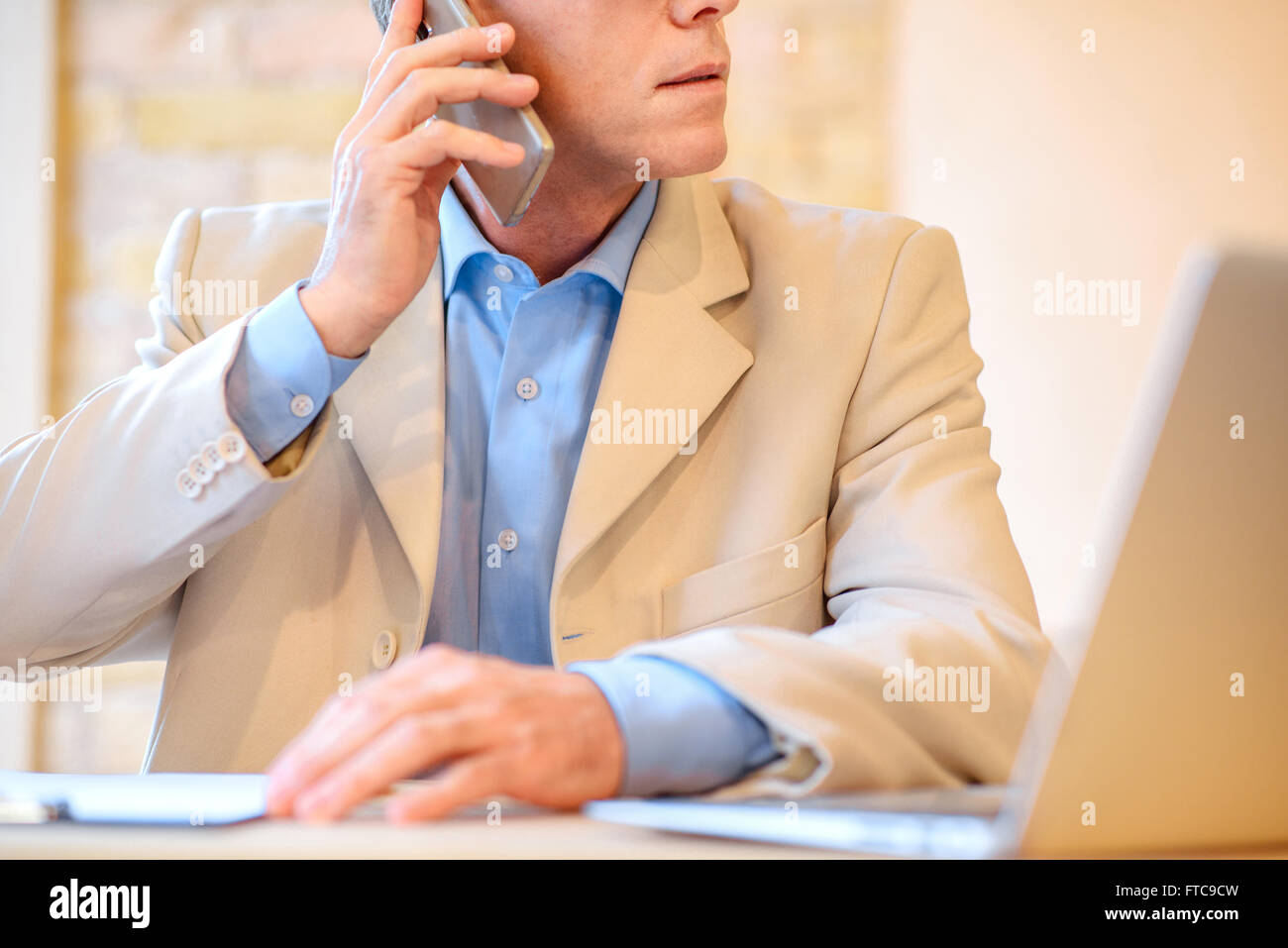 Concentrated man talking on mobile phone Stock Photo - Alamy