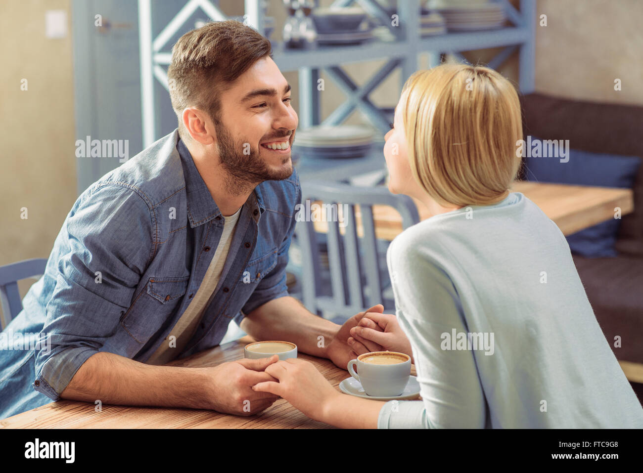 Loving couple sitting at the table Stock Photo - Alamy