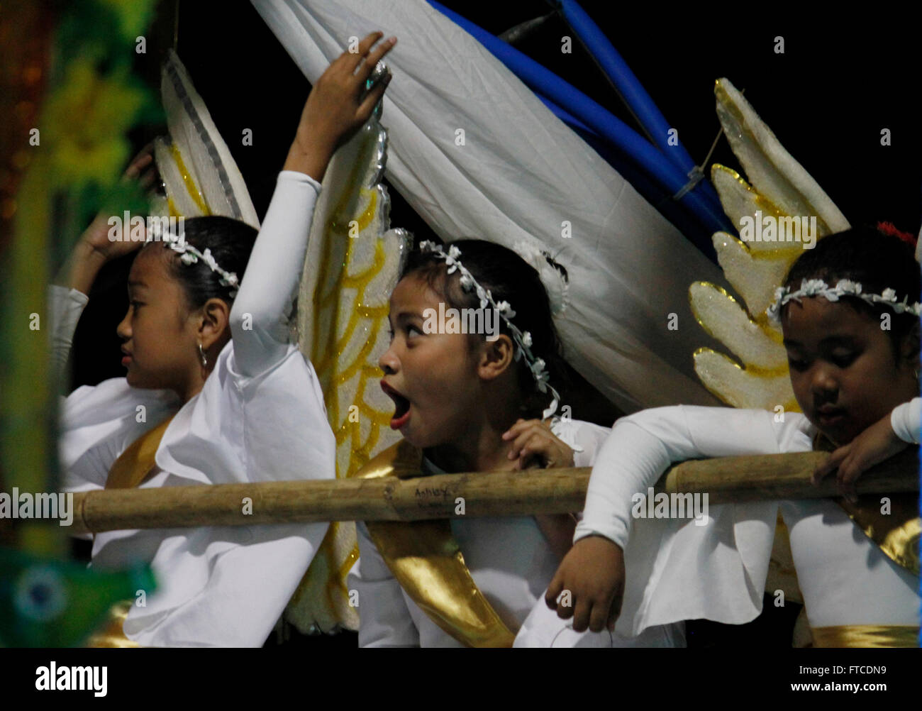 A girl dressed as an angel gestures before the start of the Salubong ...