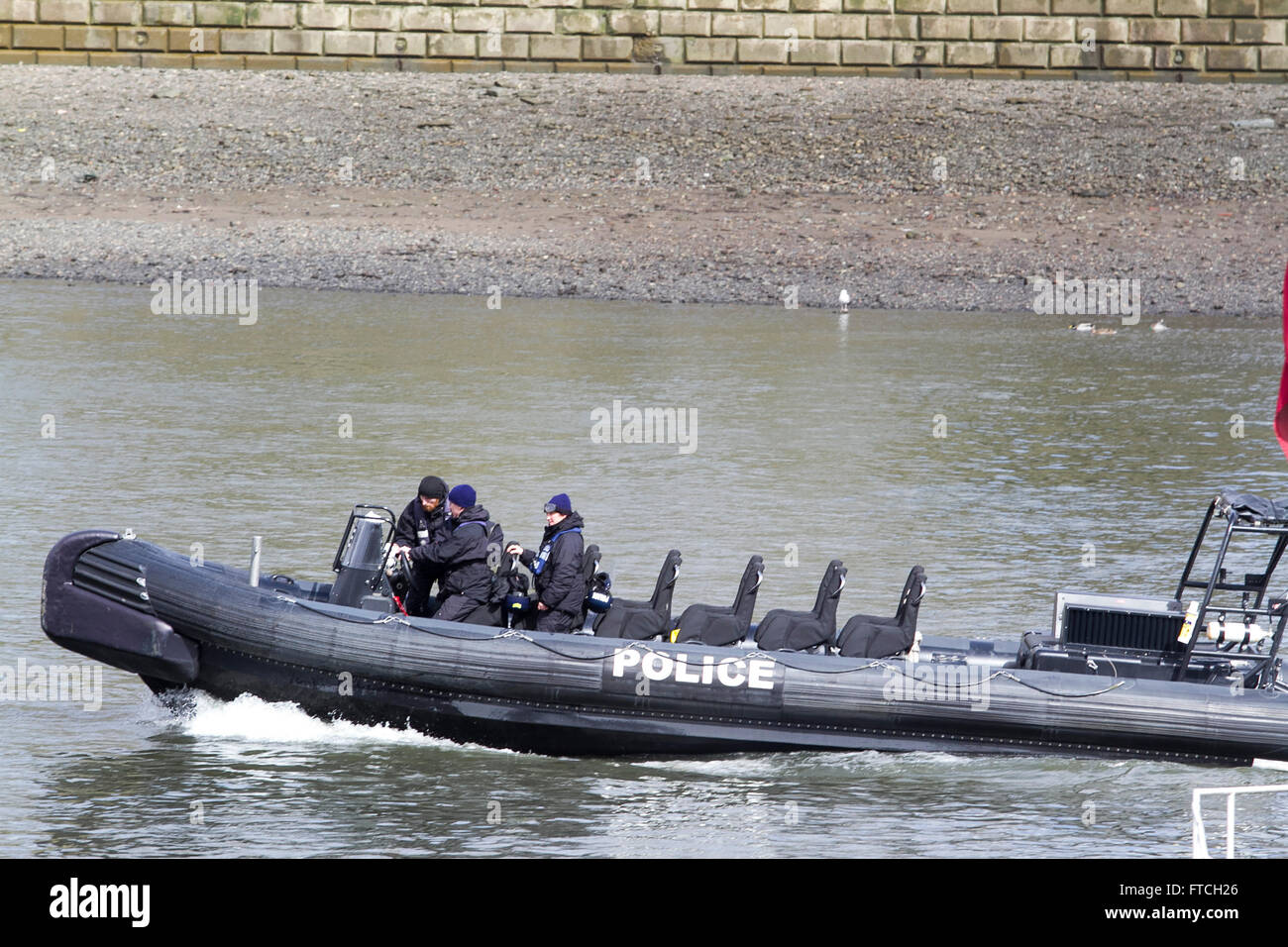Putney London, UK. 27th March 2016. A police dinghy speed boat patrols ...