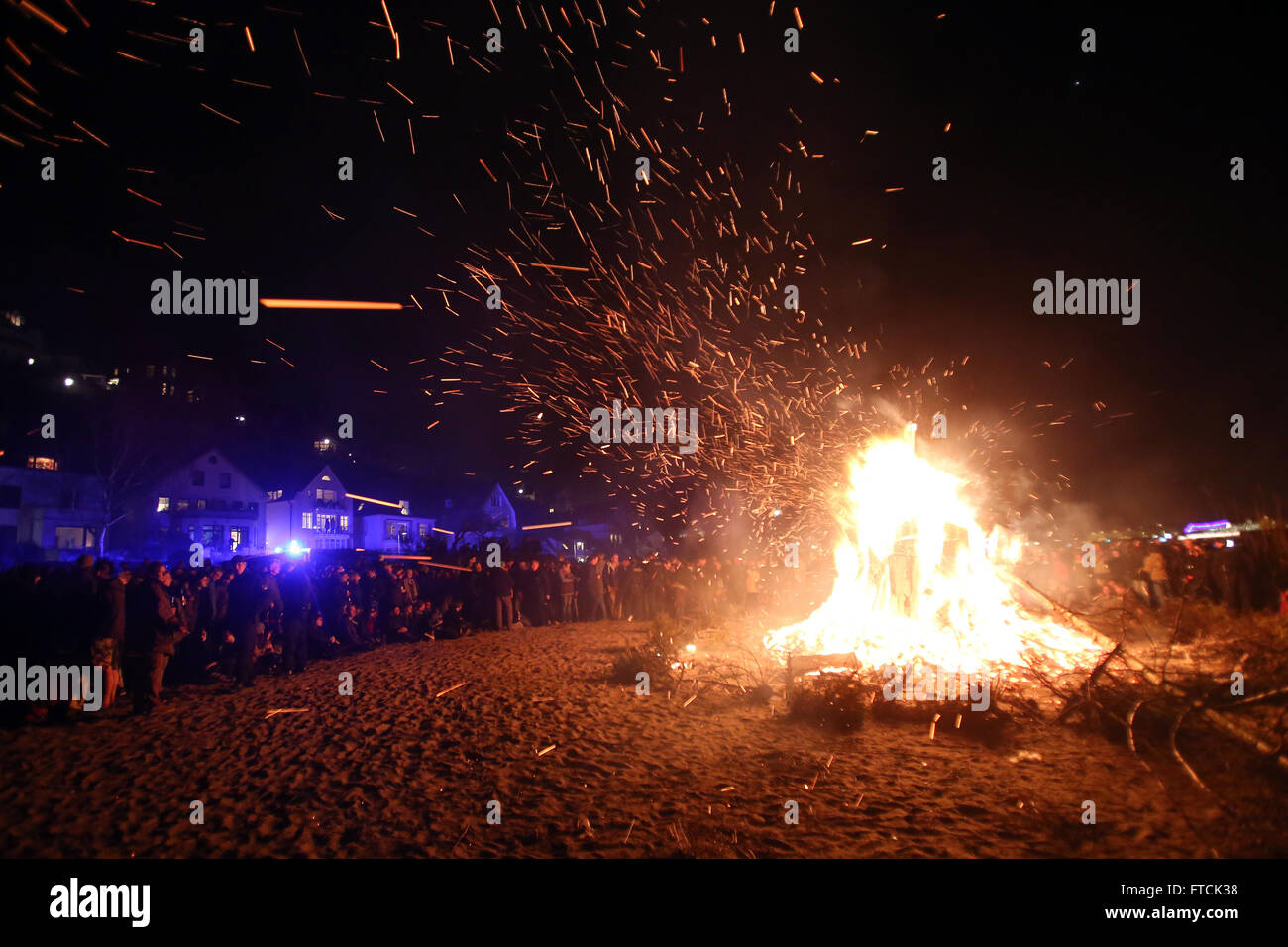 Hamburg, Germany. 26th Mar, 2016. People watch an Easter bonfire by the ...