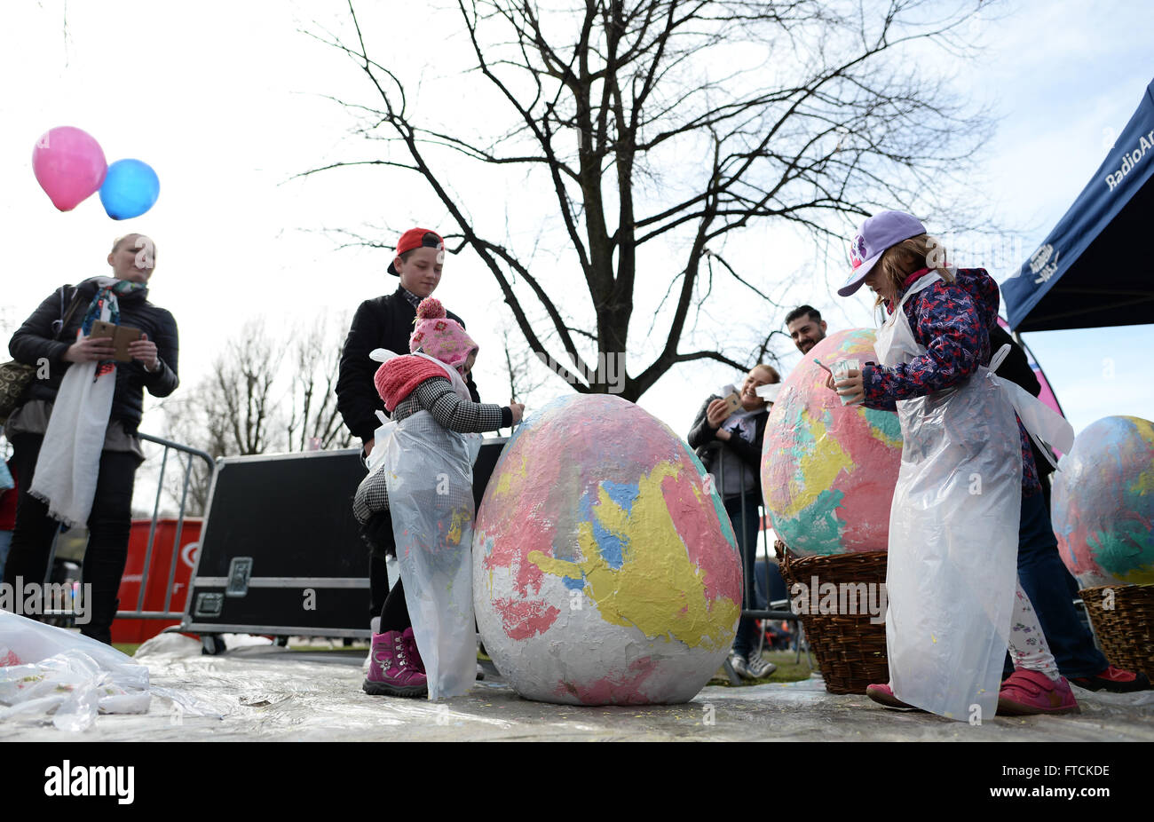 Munich, German. 27th Mar, 2016. Aylin paints an oversized Easter egg at ...