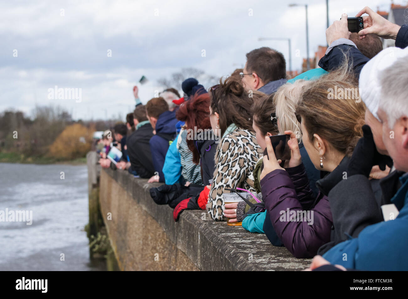 Spectators in Barnes at the Oxford and Cambridge University Boat Race ...