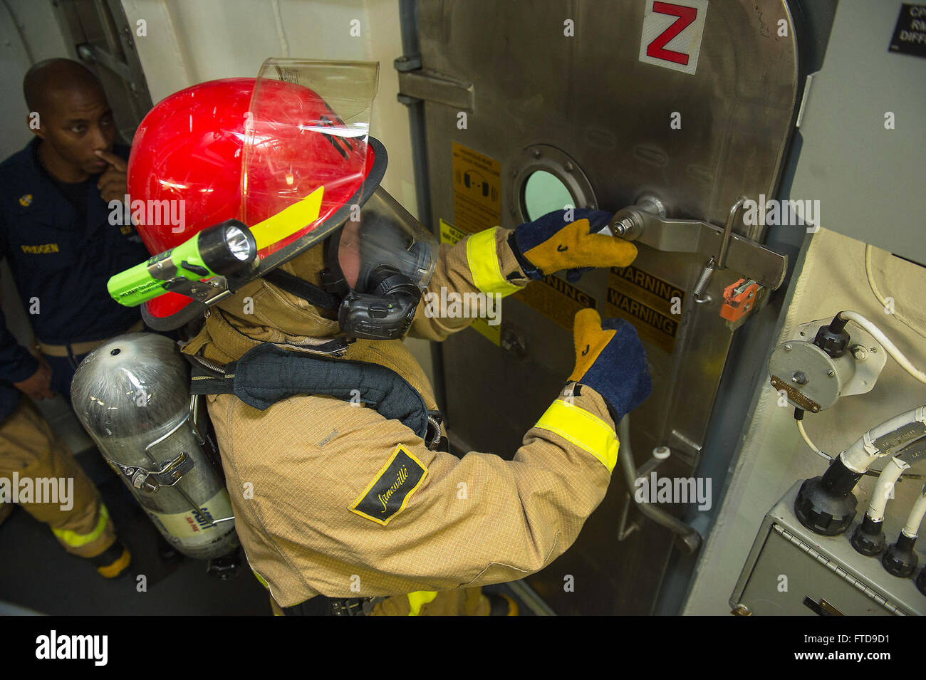 Aboard the USS *Gravely* (DDG 107), Chief Damage Controlman Reginald ...