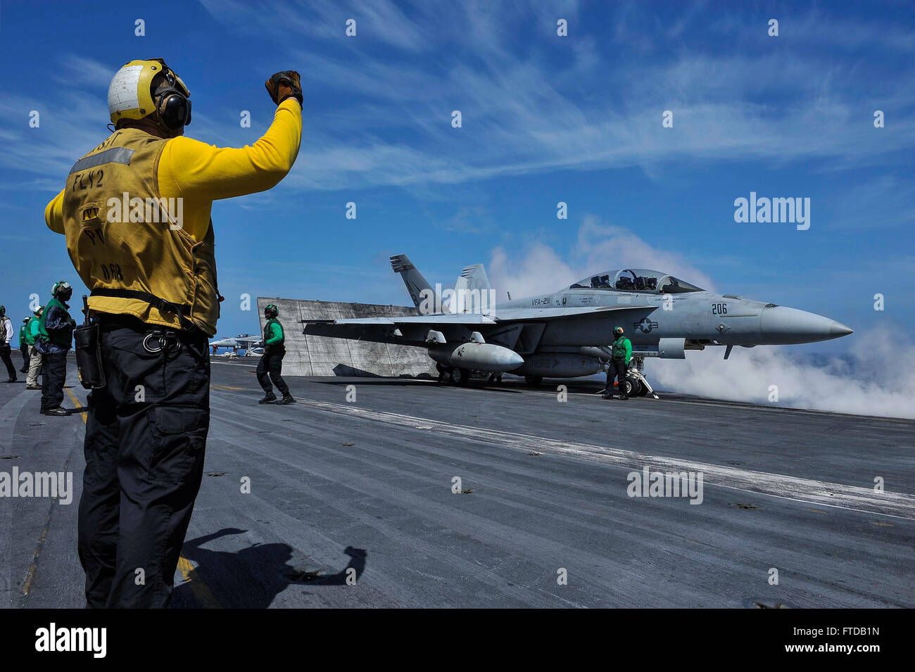 Aircraft handler signals aboard carrier hi-res stock photography and ...