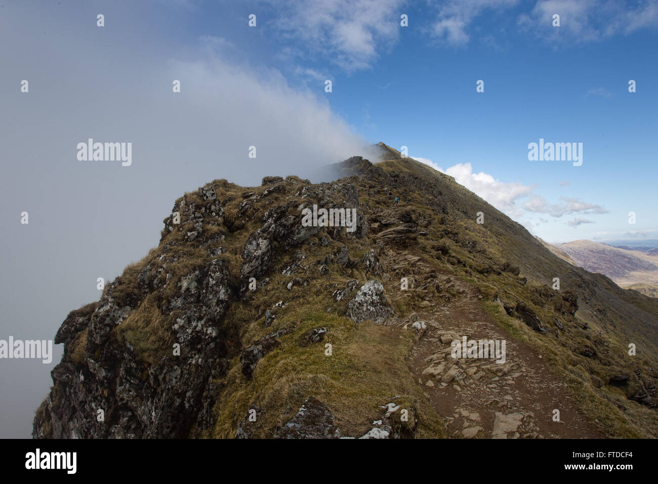 Clouds flow over the Crib Goch Ridge while ascending Snowdon along the ...