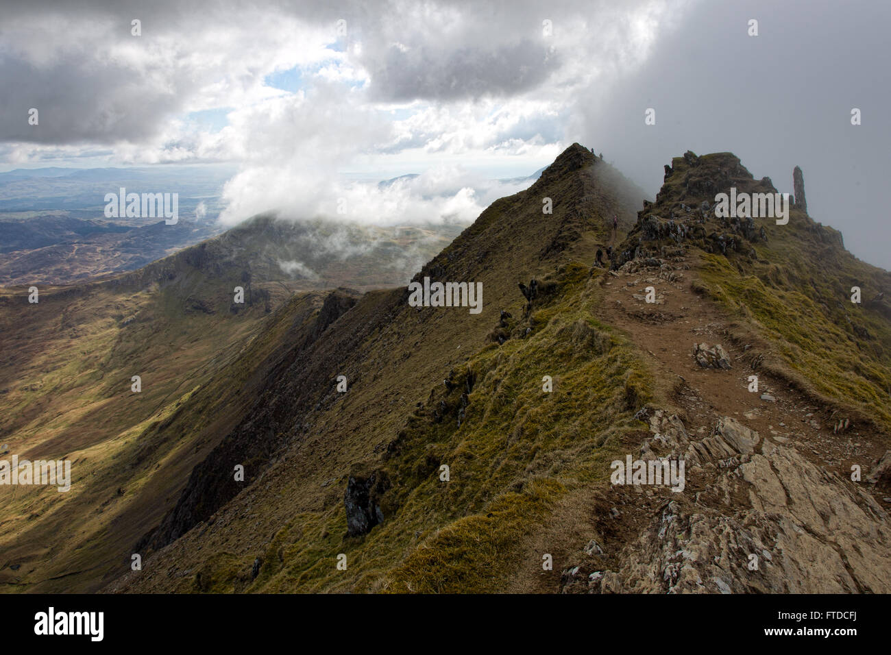 Clouds flow over the Crib Goch Ridge while descending, Snowdon along ...
