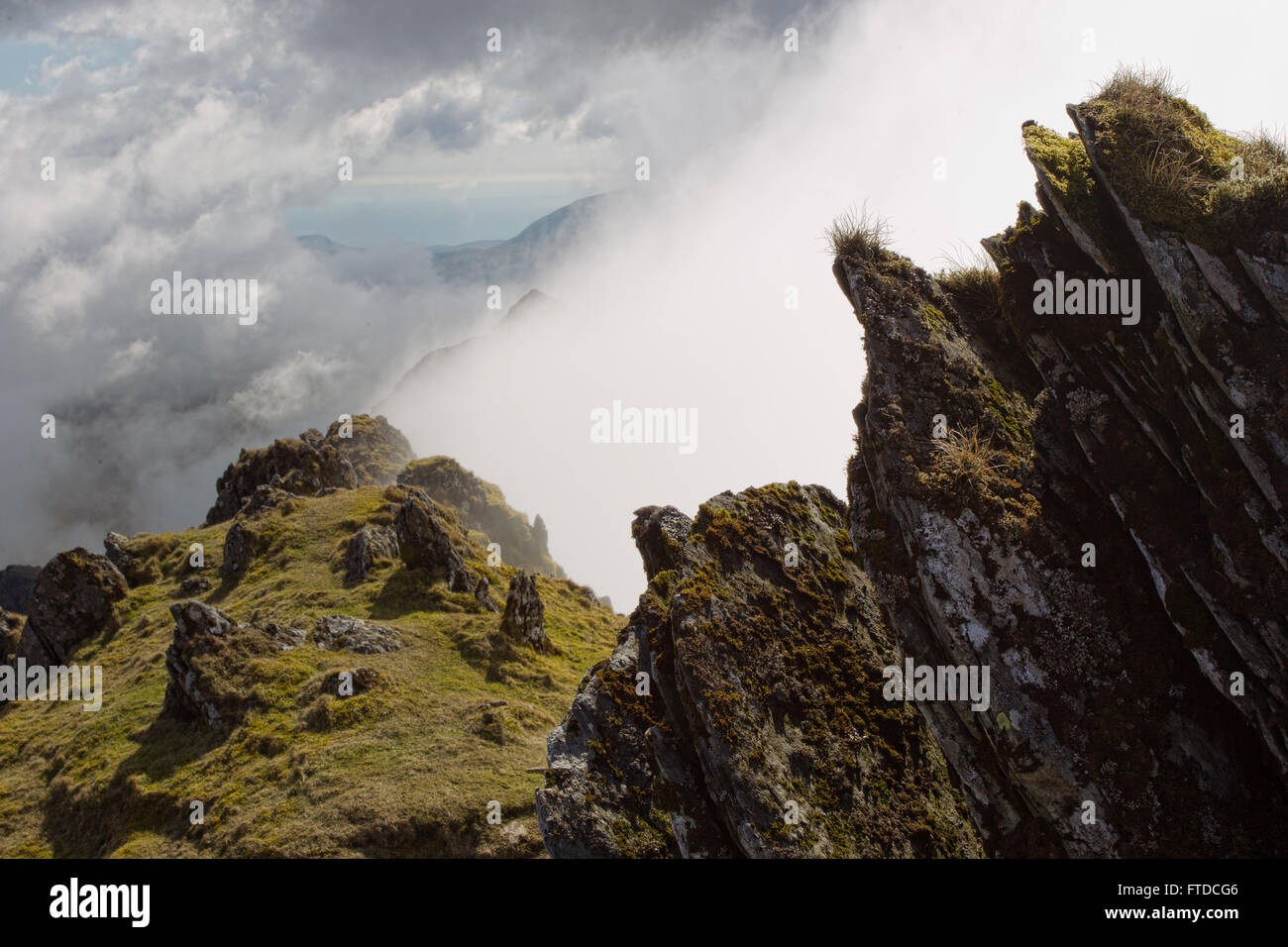 Clouds flow over the Crib Goch Ridge while descending, Snowdon along ...