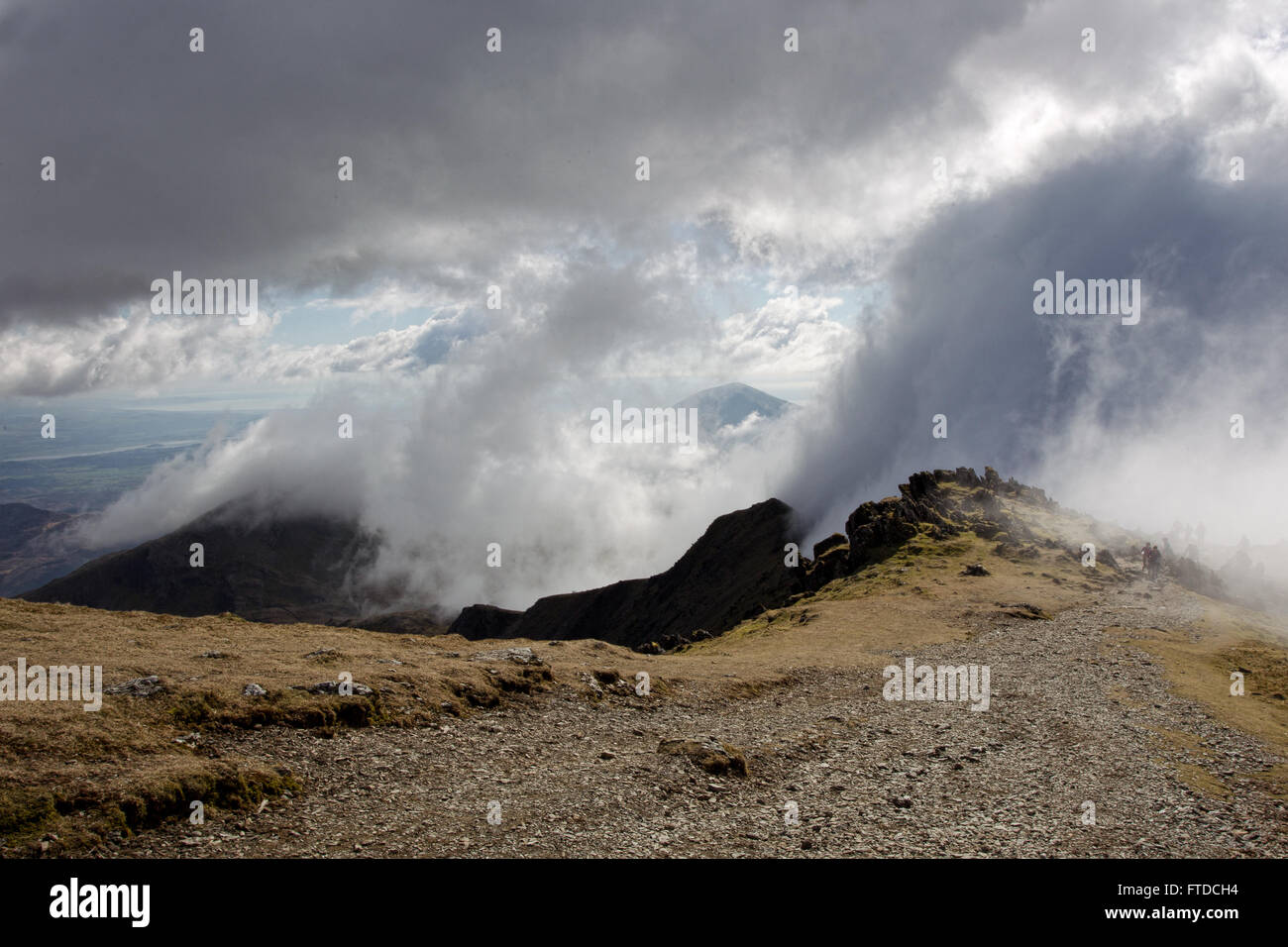 Clouds flow over the Crib Goch Ridge while descending, Snowdon along ...