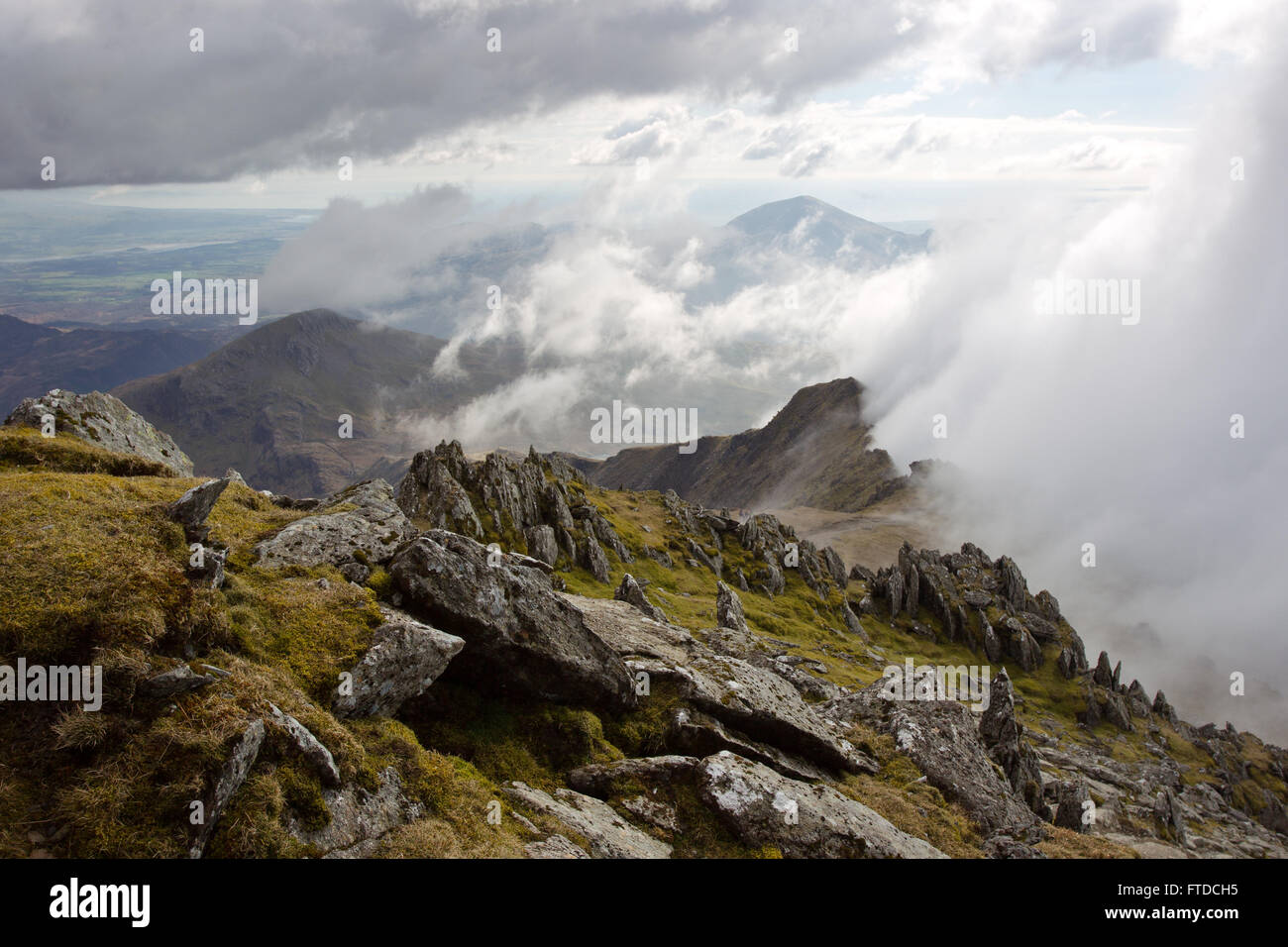 Clouds flow over the Crib Goch Ridge while descending, Snowdon along ...