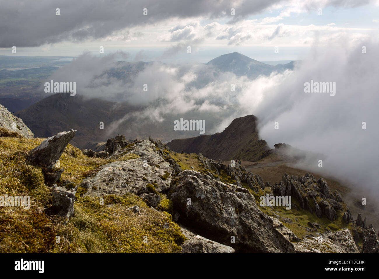 Clouds flow over the Crib Goch Ridge while descending, Snowdon along ...