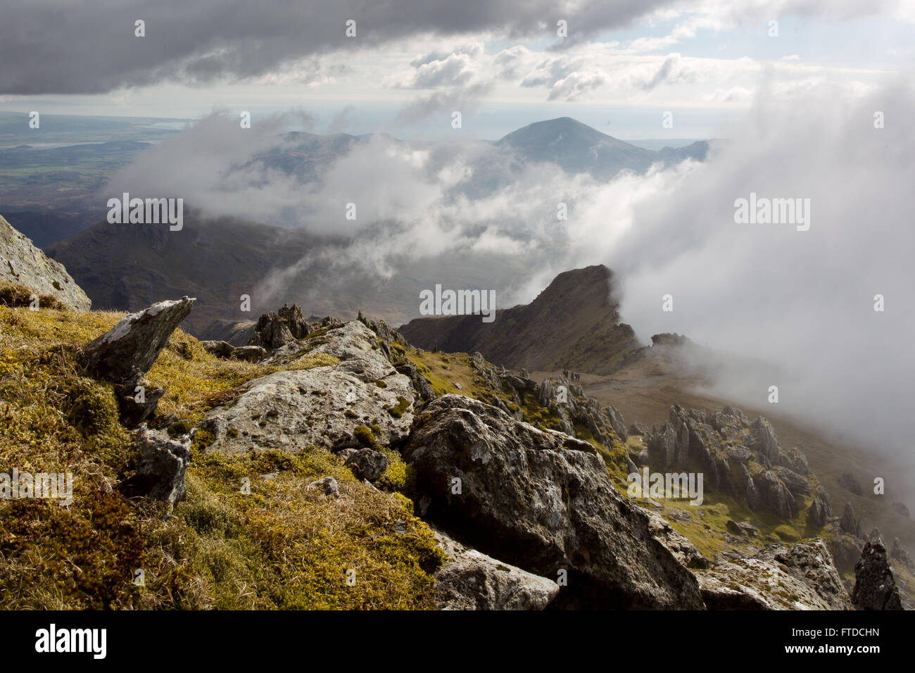 Clouds flow over the Crib Goch Ridge while descending, Snowdon along ...